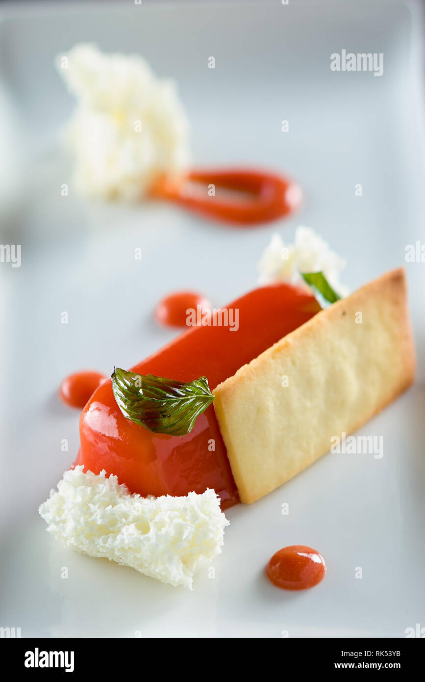 Chicken roulade with prosciutto, artichoke and emulsion on a white ...