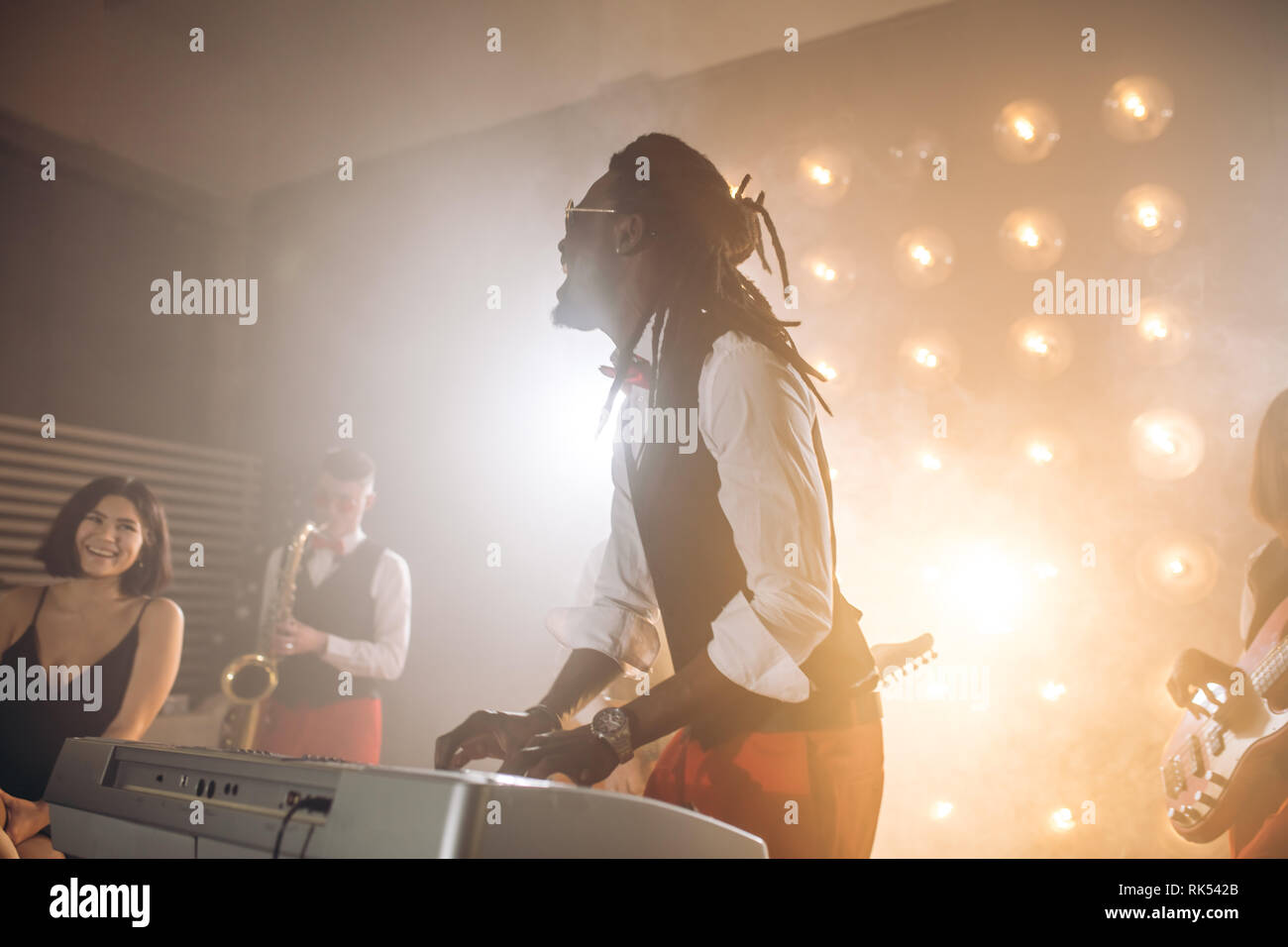 funny musician entertaining his friends during rehearsal. close up side ...