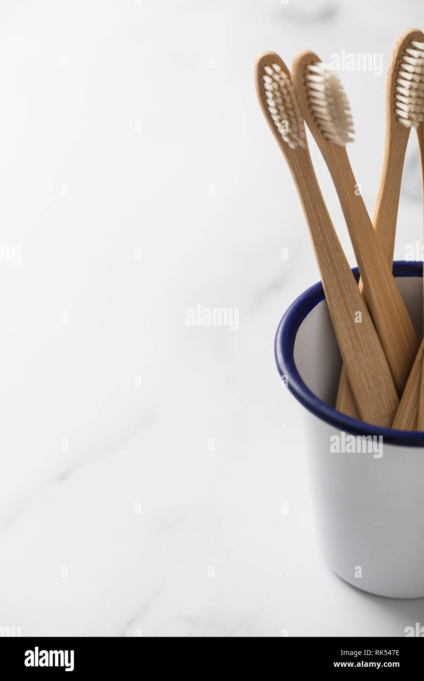Wooden bamboo toothbrushs in a white pot Stock Photo - Alamy
