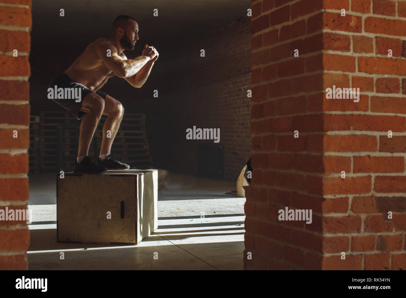 Box jump plyo exercise - young caucasian man doing functional workout ...