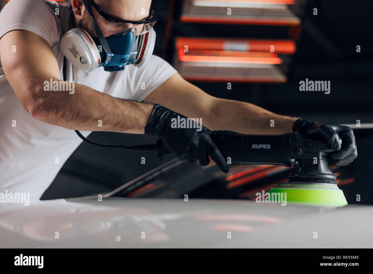 awesome man removing dirt, grease, scraatches and scrapes from ...