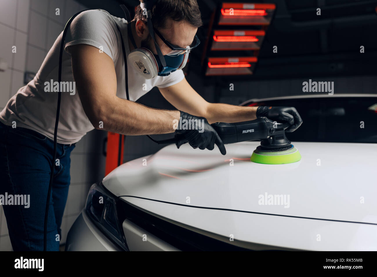 young man testing a speed electric car polisher, close up photo.final ...