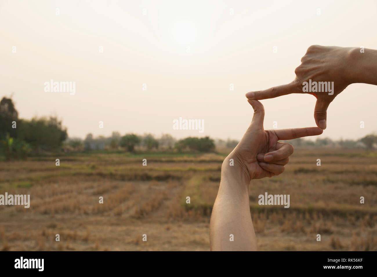 Hands making frame with sunset. Close up of woman hands making frame ...