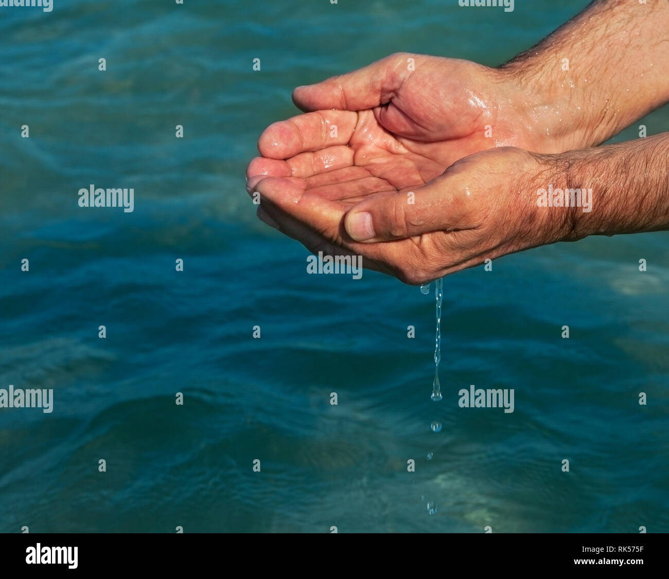 Photo of hands with sea water Stock Photo - Alamy