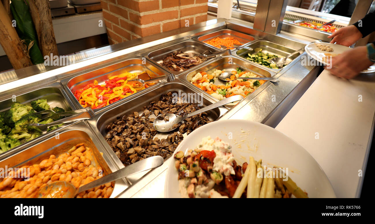 Inside a self service restaurant with many raw and cooked foods Stock ...