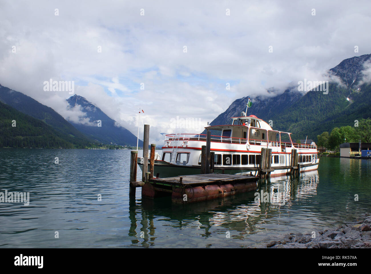 boat ready for tourists floating on the beautiful mountain lake Achen ...