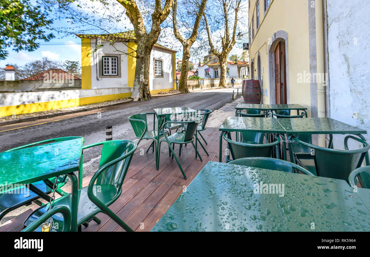 Café tables at the streets of Sintra, Portugal Stock Photo - Alamy