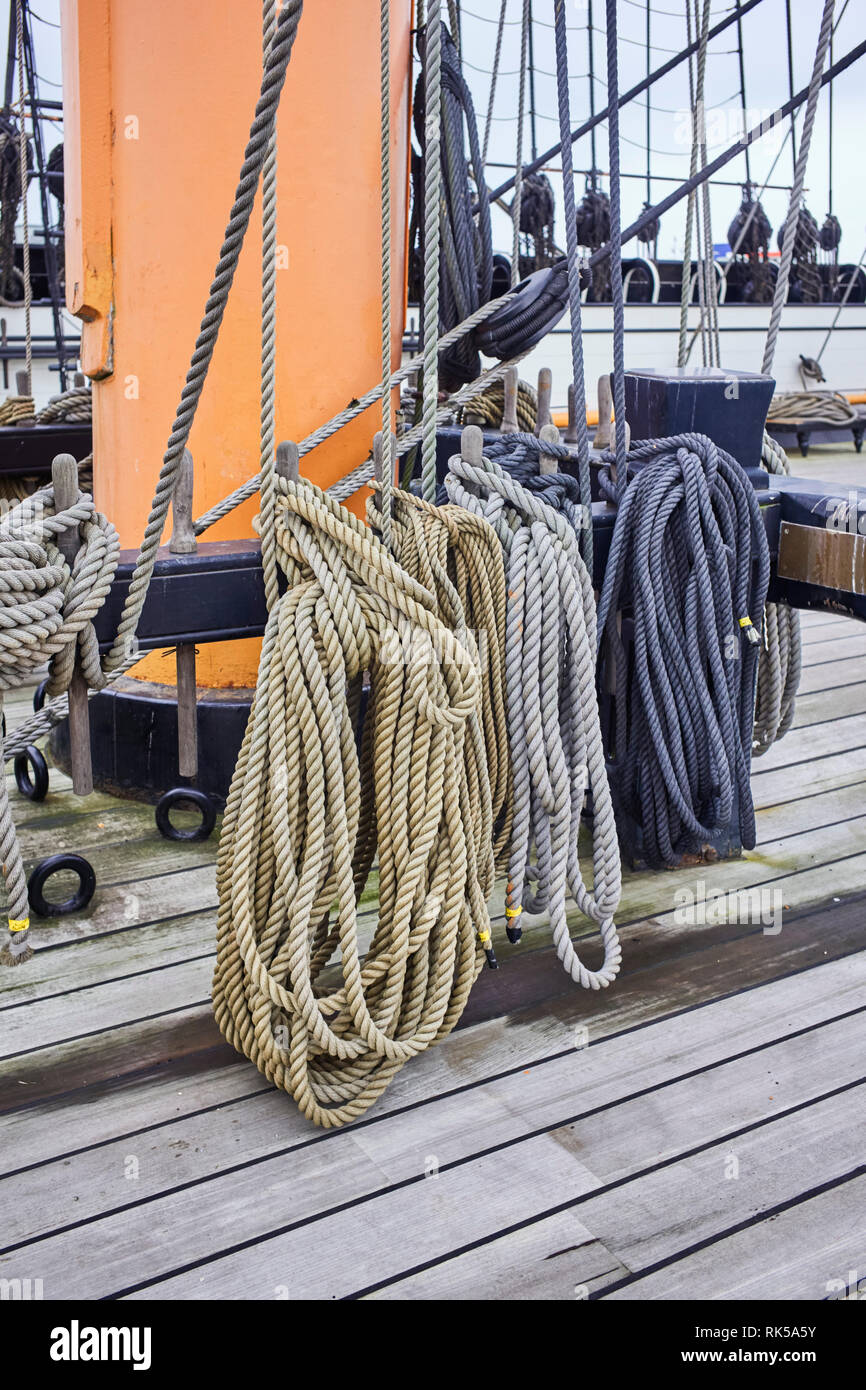 Rigging rope detail on HMS Warrior being held in place by belaying pins ...