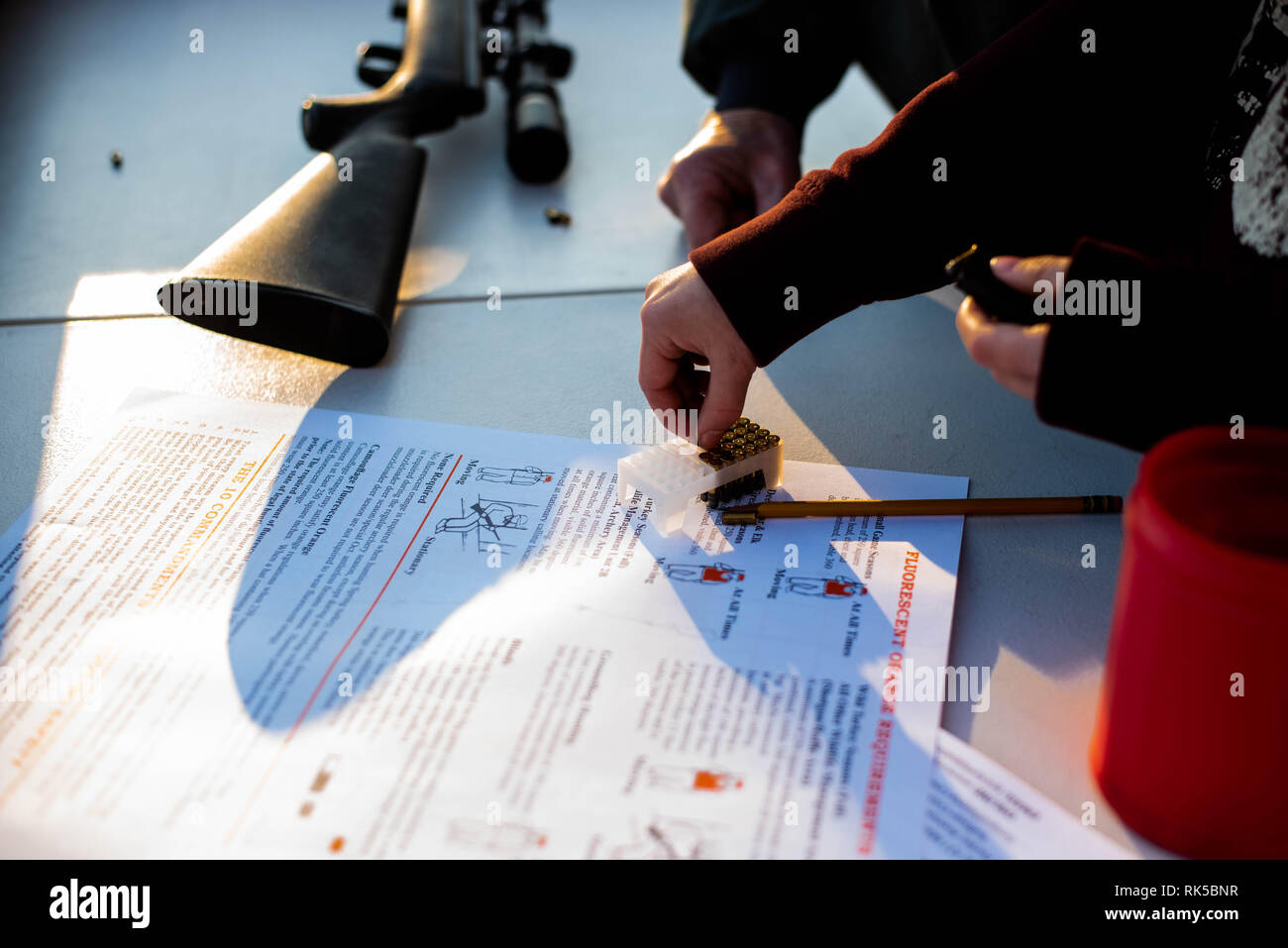 A grandfather and his 12-year old grandson count bullets from a 22 ...