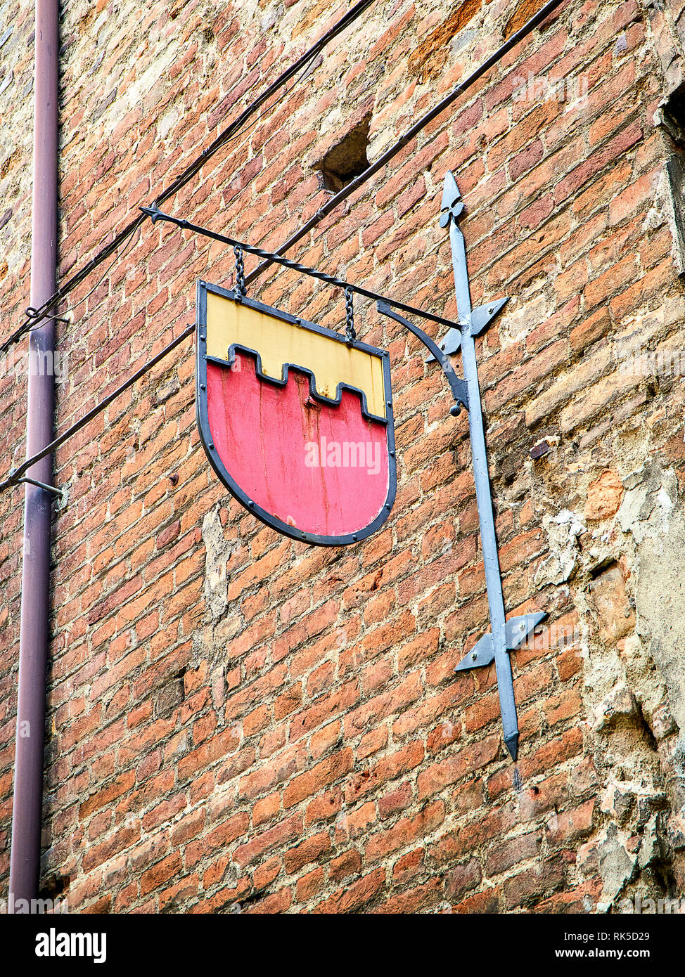 Metallic plaque of a Medieval Shield on a brick facade of Asti ...