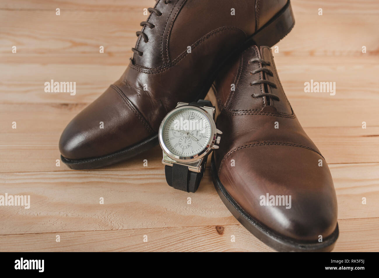 Shoes and watch as accessories to dress elegantly Stock Photo - Alamy