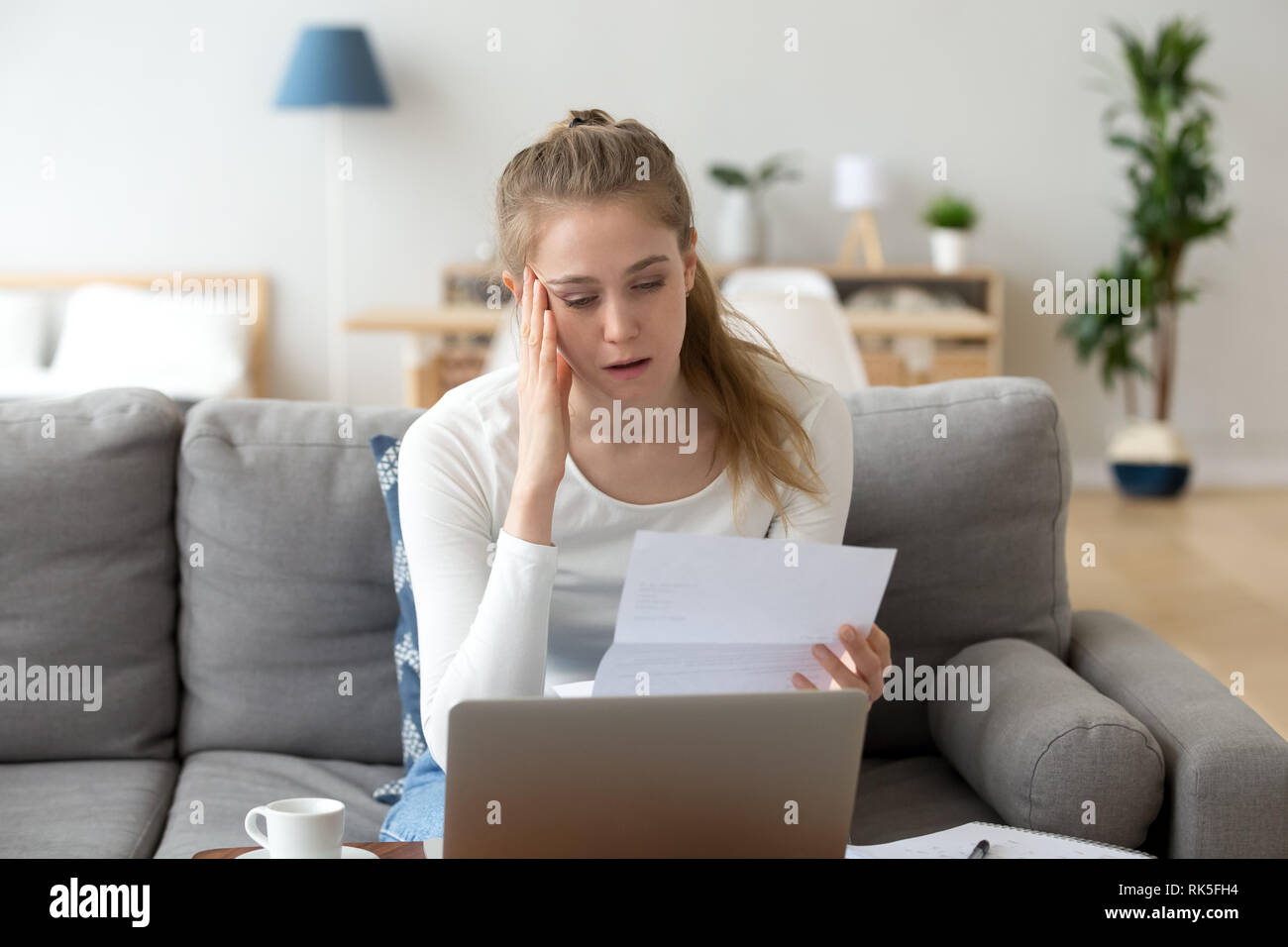 Upset frustrated girl reading bad news in paper letter Stock Photo - Alamy