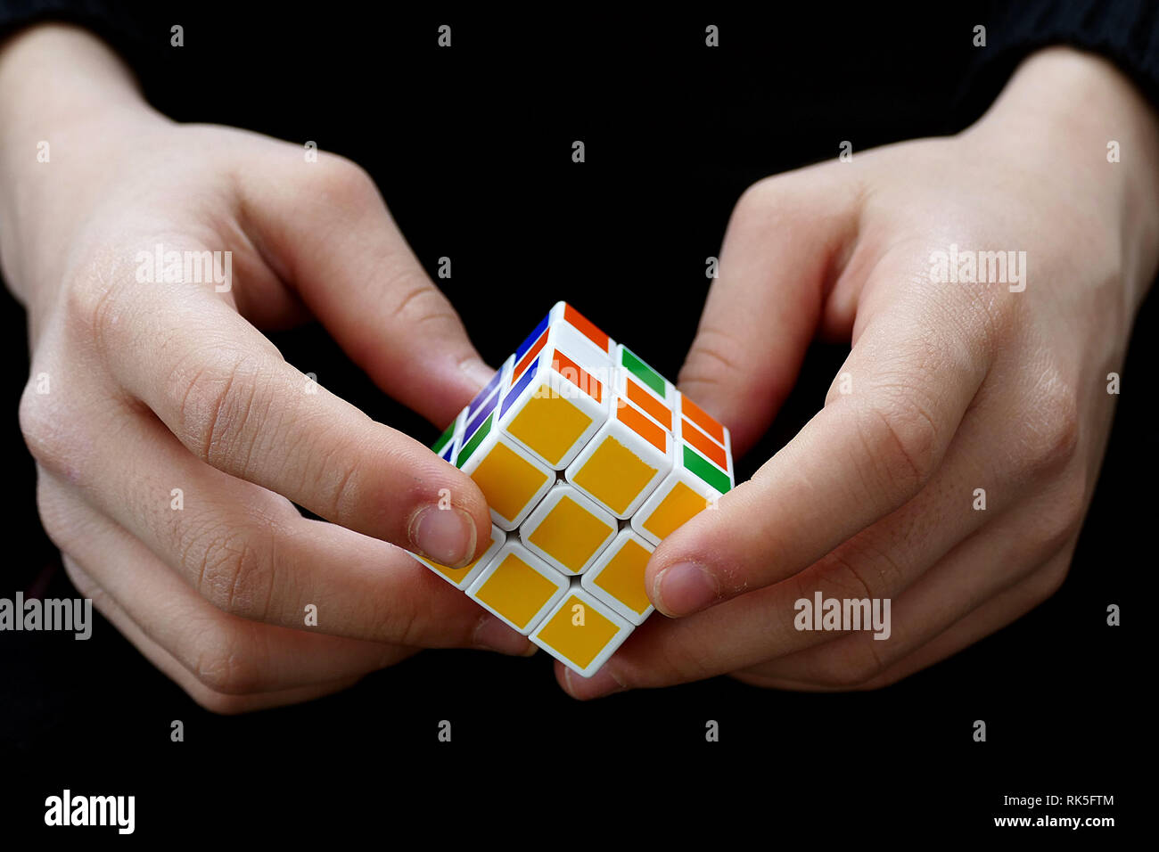 a person trying to equalize the colors of the intelligence cube Stock ...