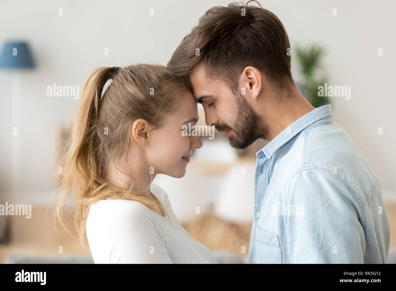 Sincere couple enjoying tender warm feelings touching foreheads Stock ...