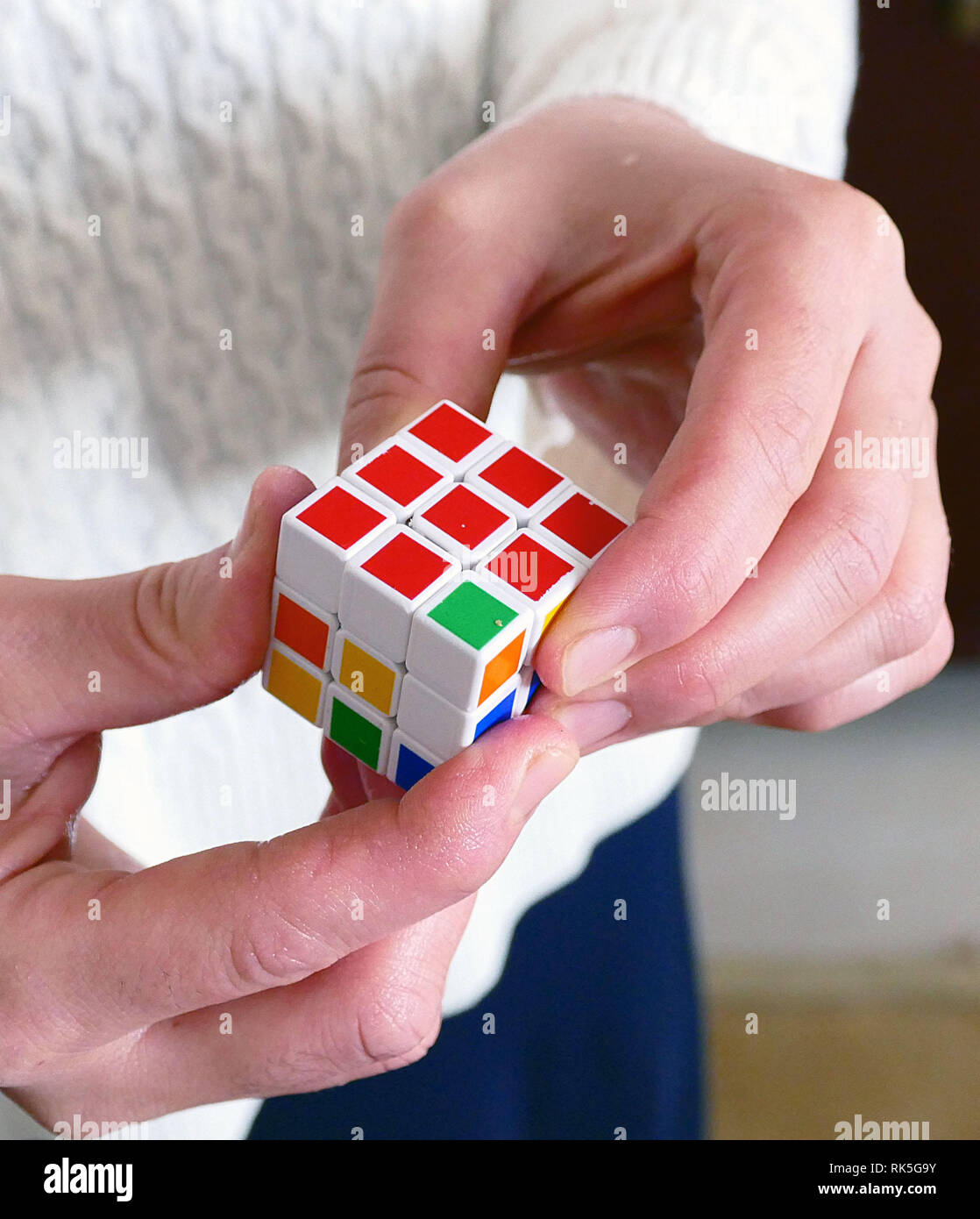 a person trying to equalize the colors of the intelligence cube Stock ...