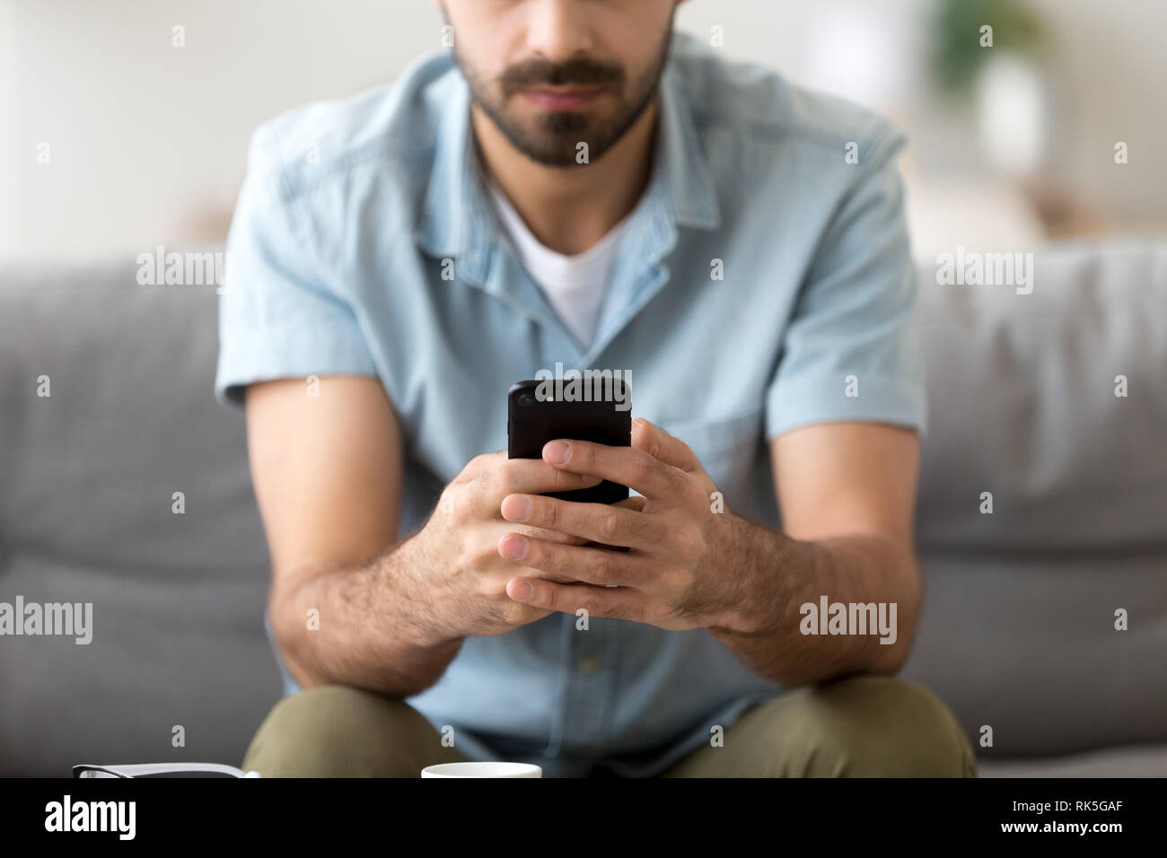 Man holding phone in hands texting message using mobile apps Stock ...