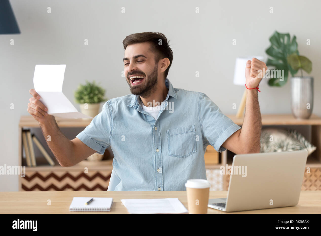 Happy young man excited reading good news holding mail letter Stock ...