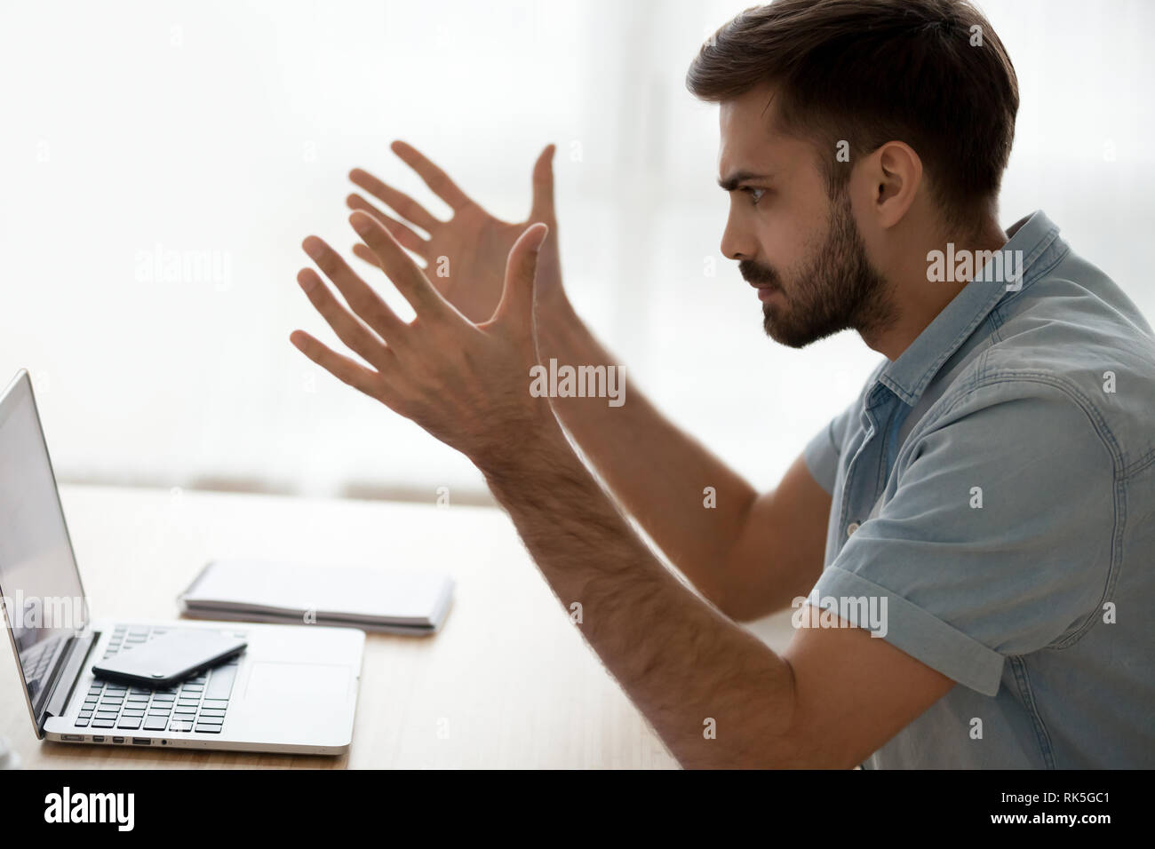 Angry annoyed young man mad about computer problem at work Stock Photo ...