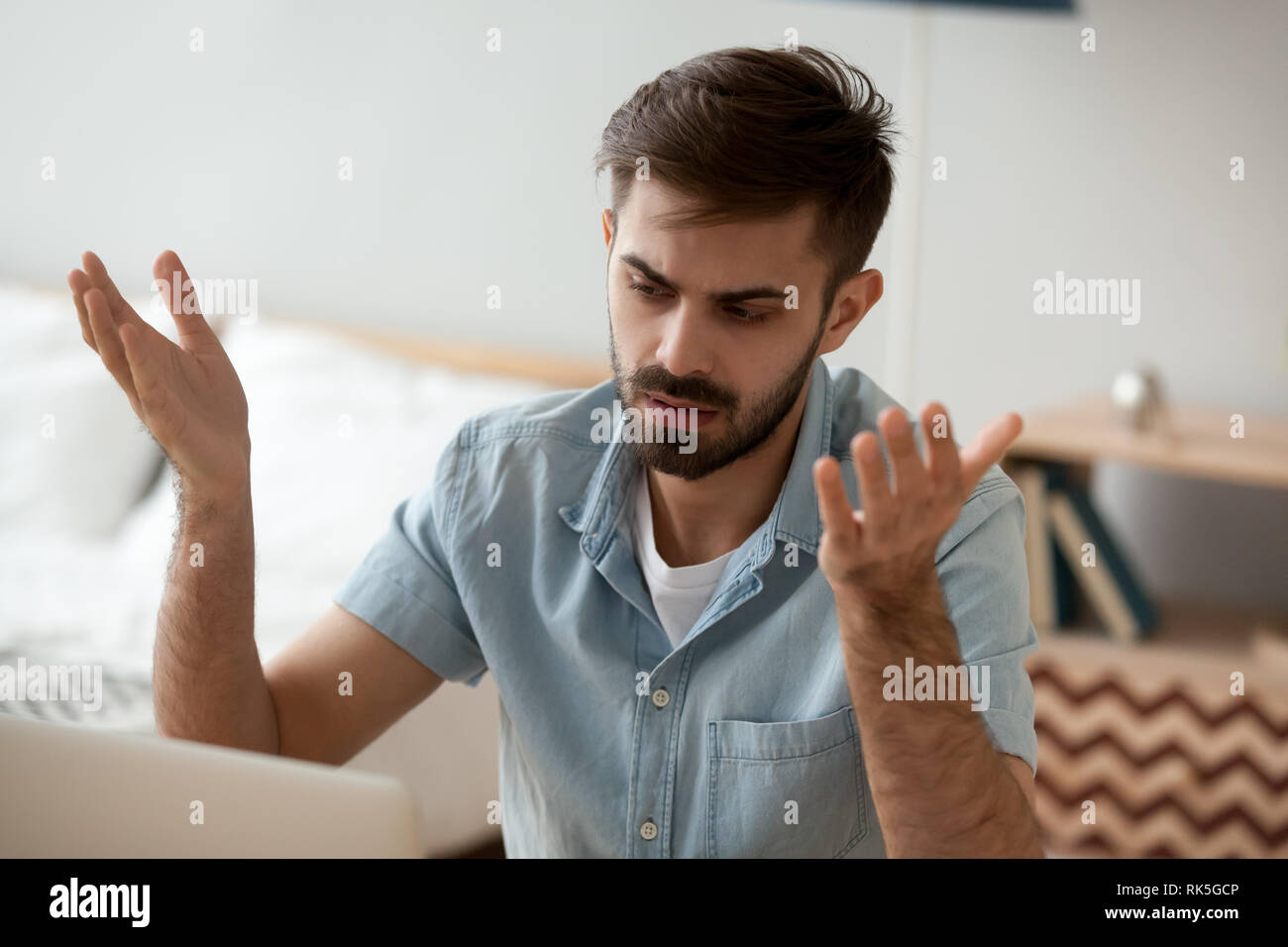 Annoyed dissatisfied young man frustrated mad about computer problem ...