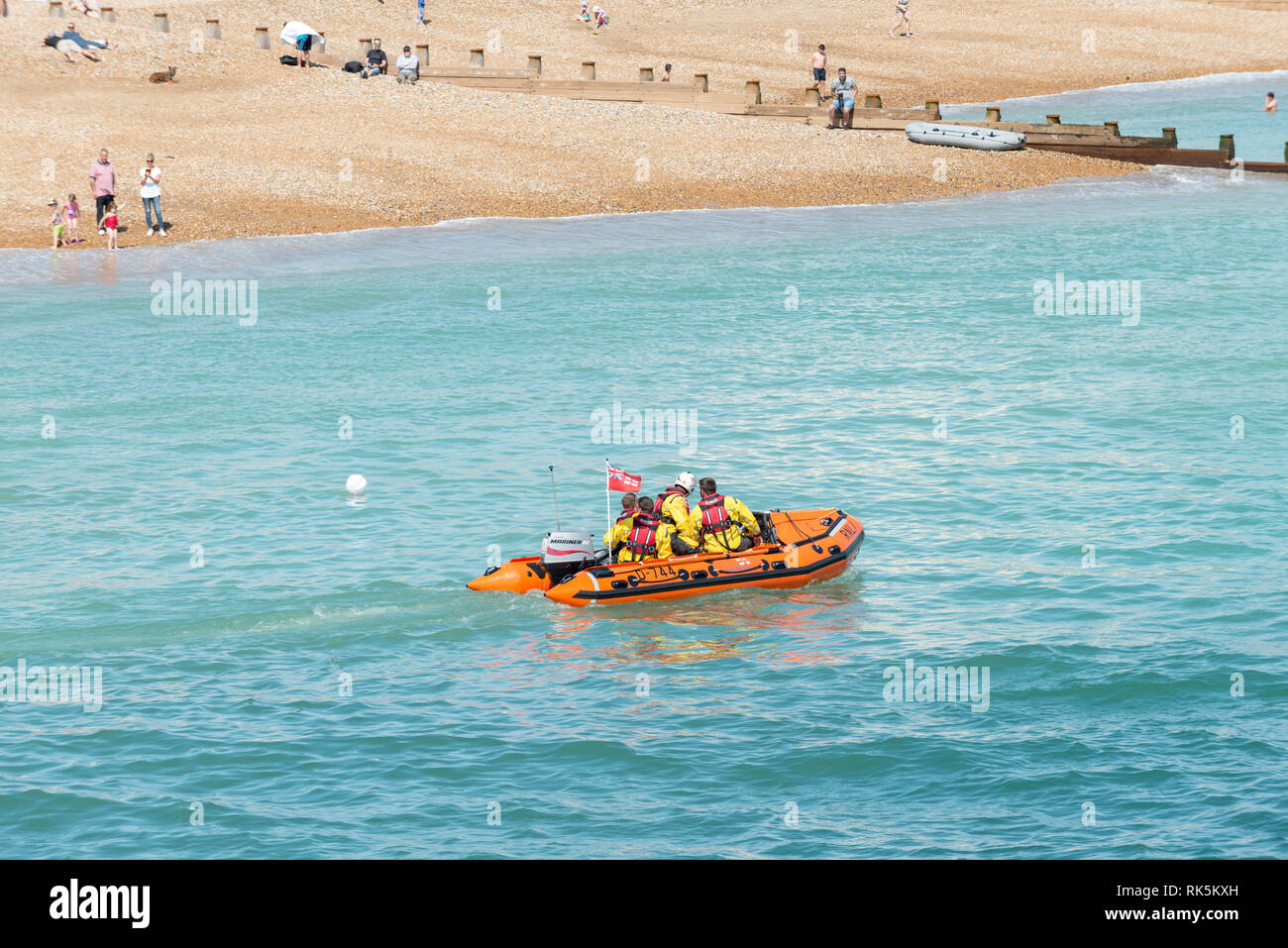 Members of the RNLI, Royal National Lifeboat Institution, patrol the ...