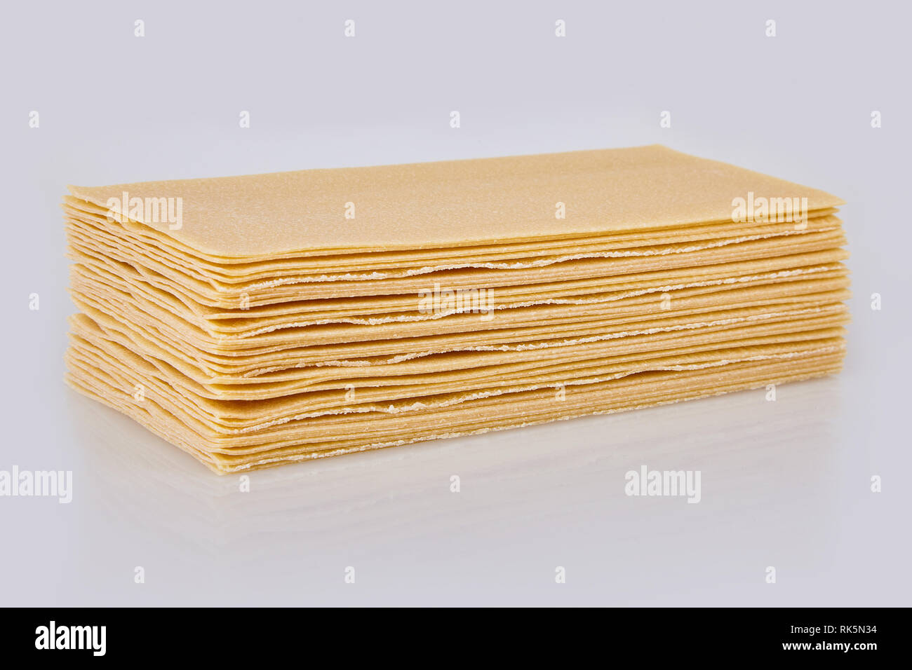 lasagne sheets stack on white background. Pile of dried uncooked ...