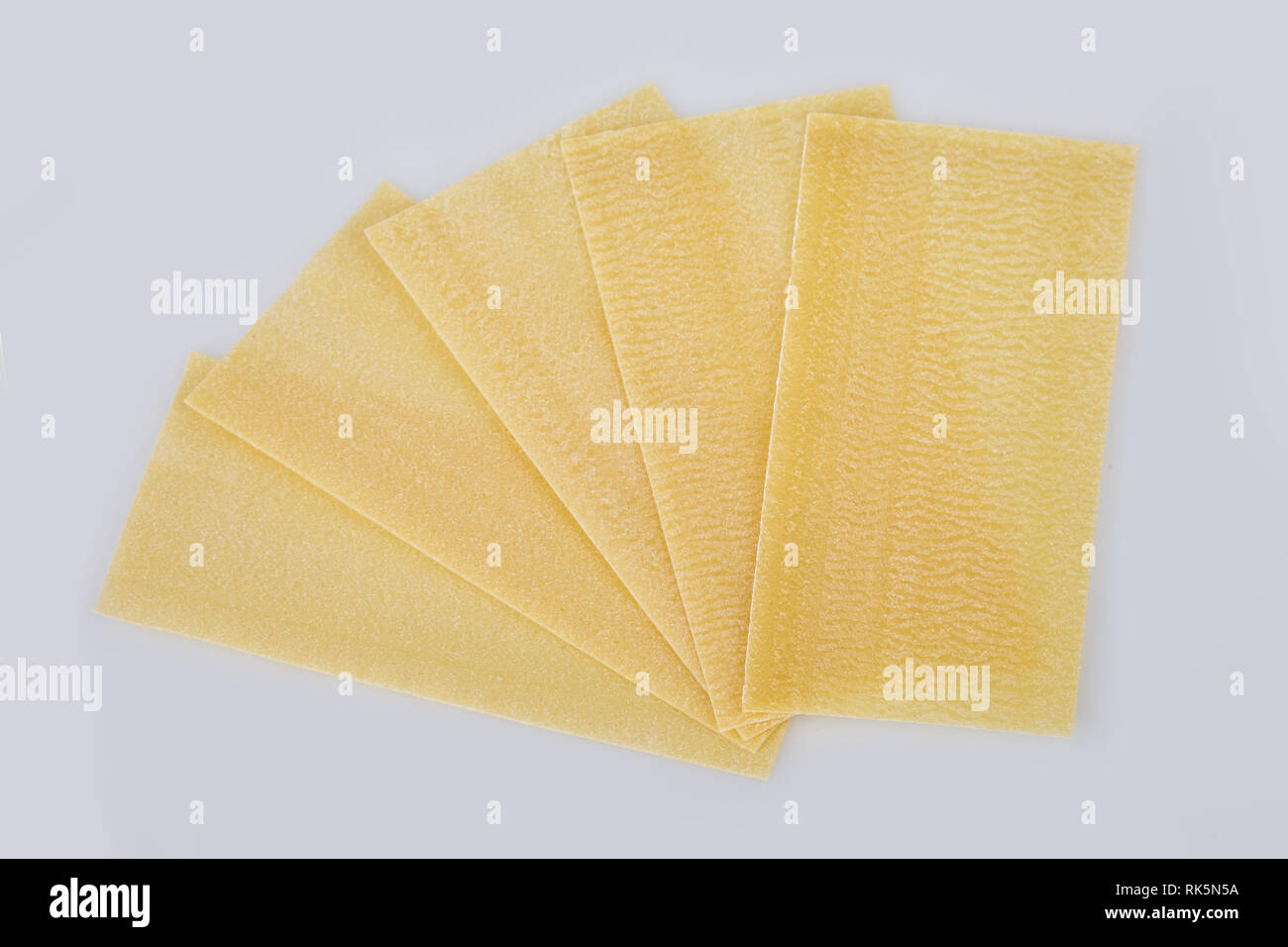 lasagne sheets stack on white background. Pile of dried uncooked ...