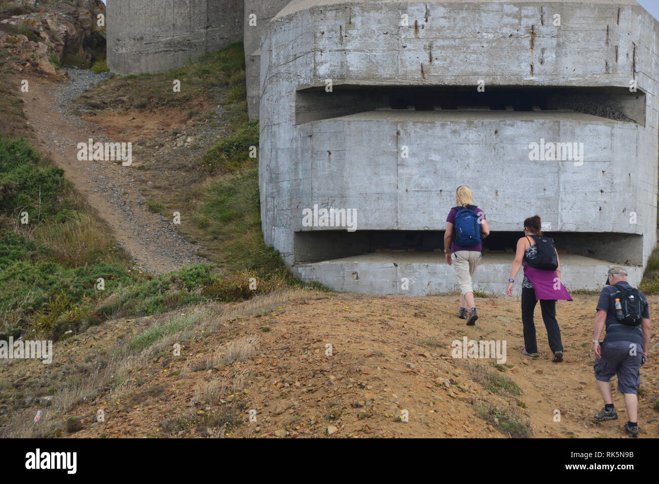 Three Hikers Walking on the Coastal Footpath to the WW2 German ...