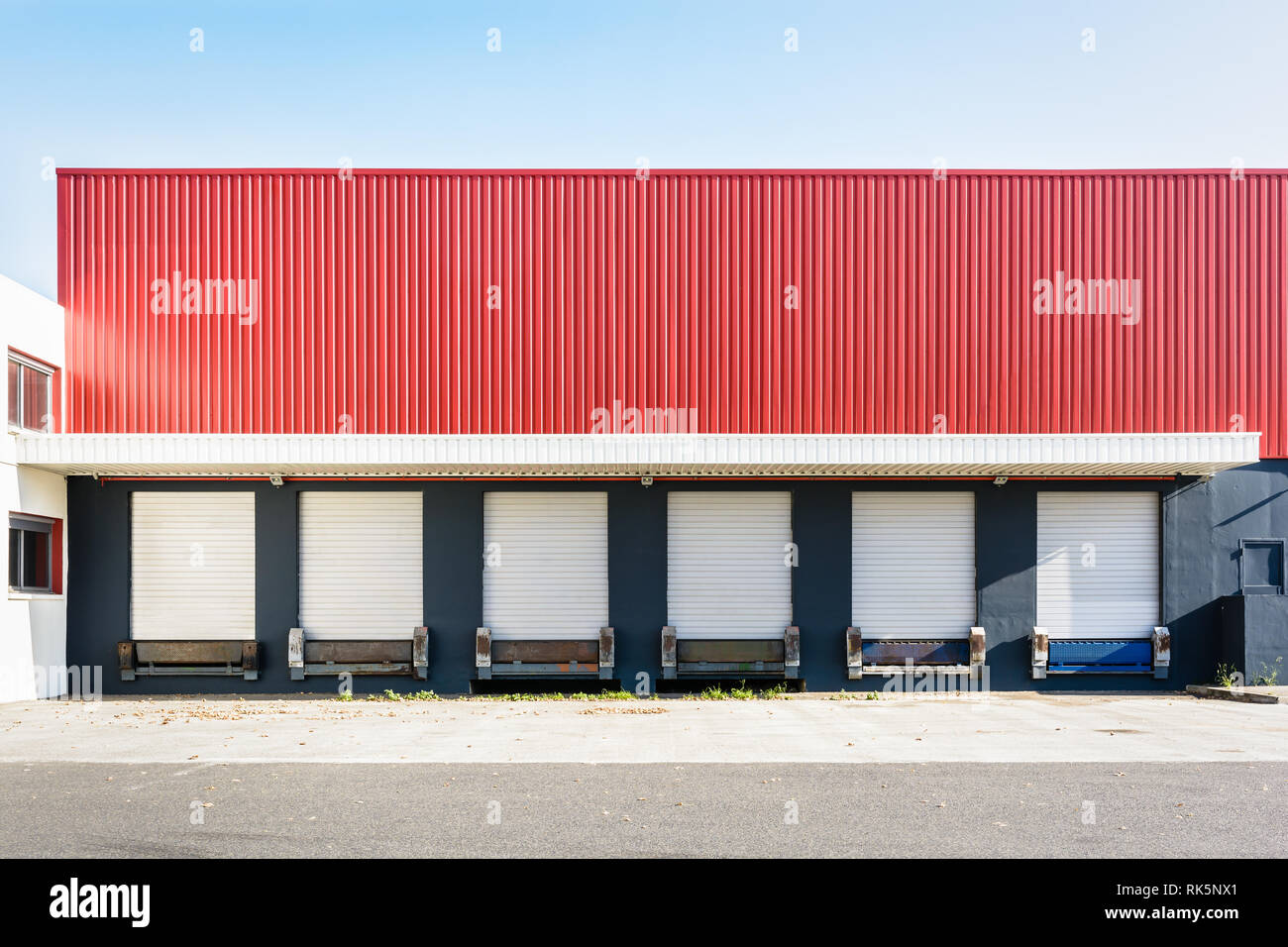 Front view of six truck loading docks at a warehouse with white roller ...