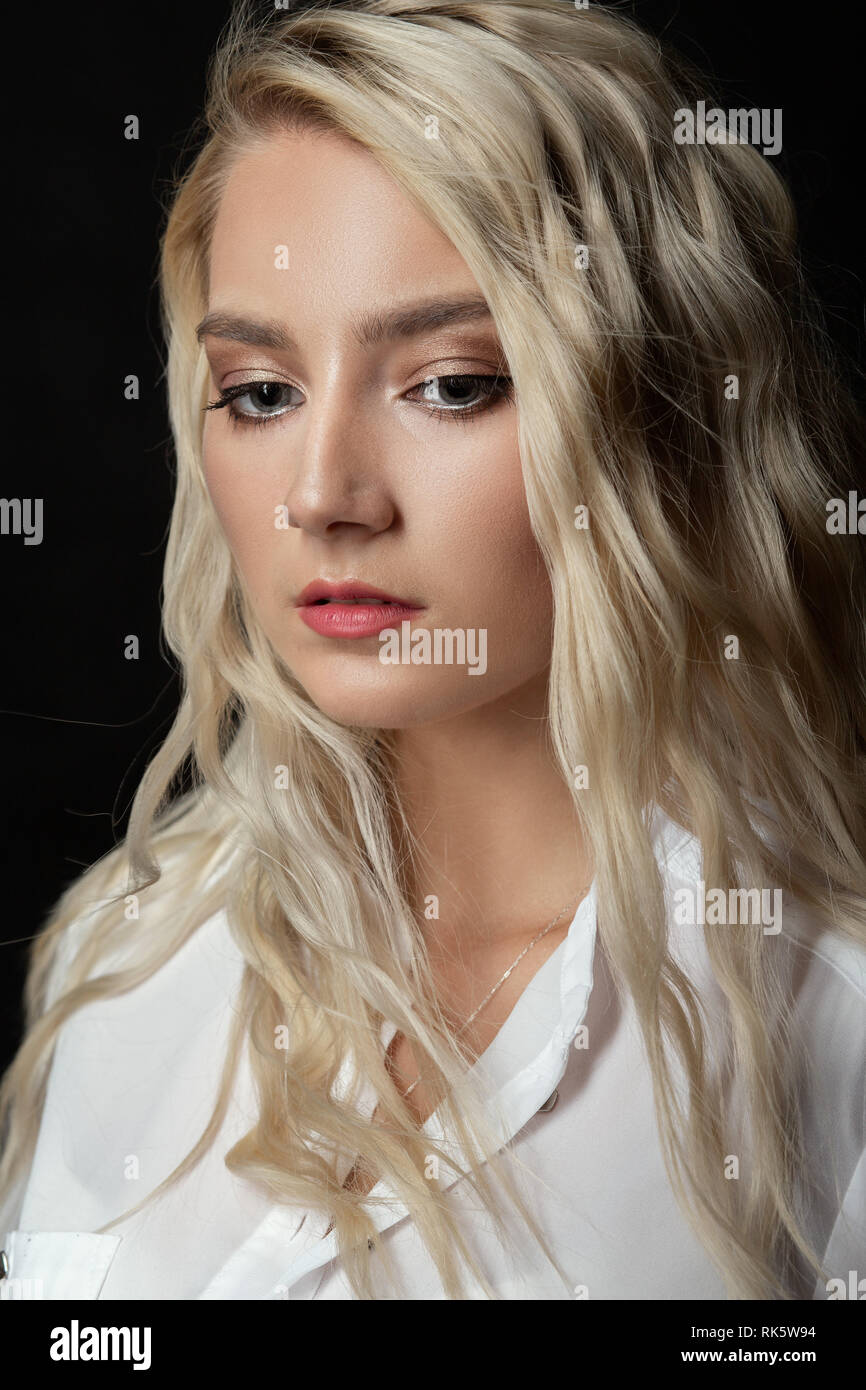 serious pensive young woman thinker on black background looking at ...