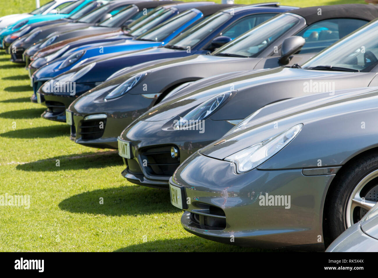 Porsche cars in line parked on grass Stock Photo - Alamy