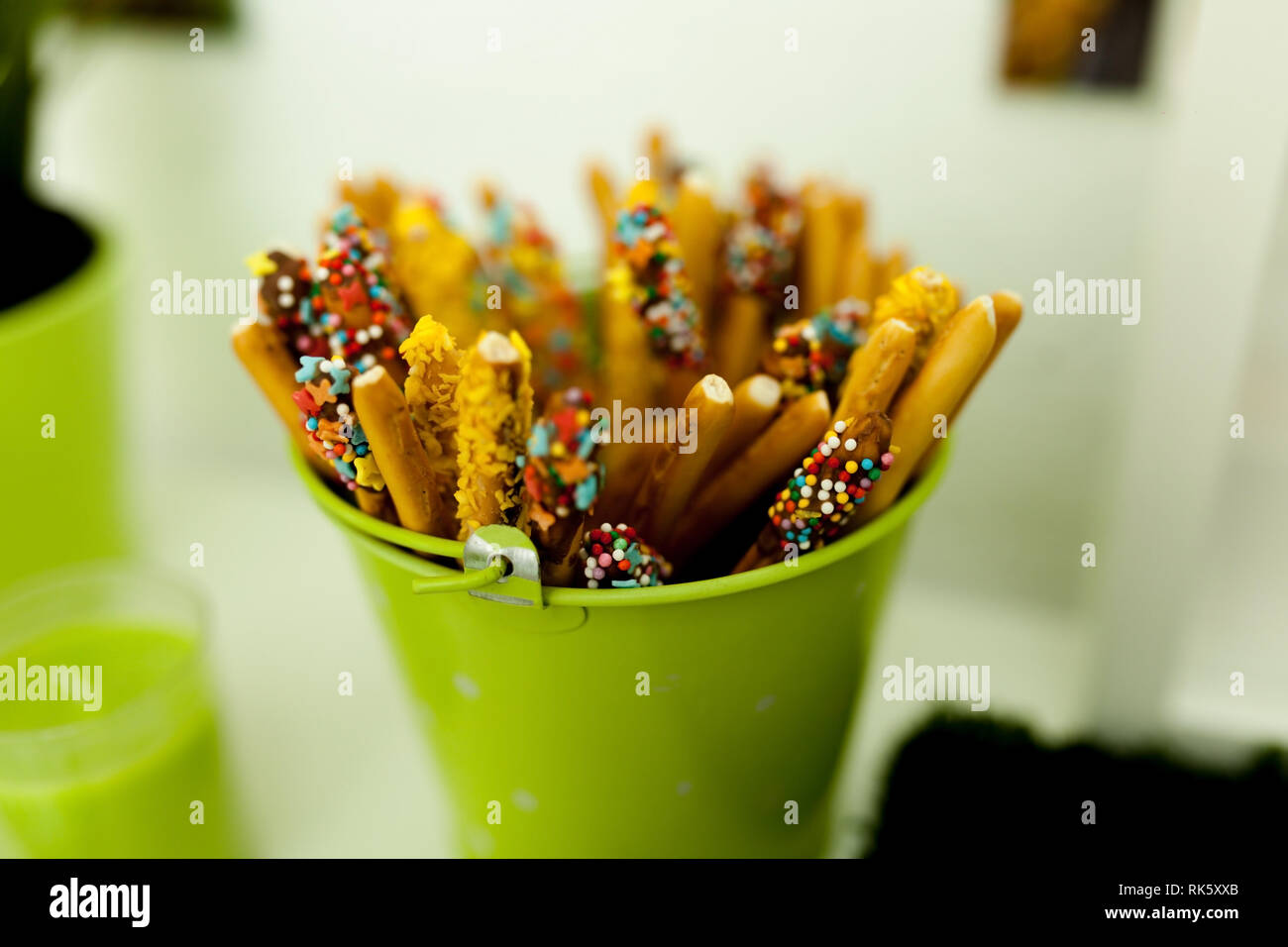 green bucket with sweets Stock Photo - Alamy