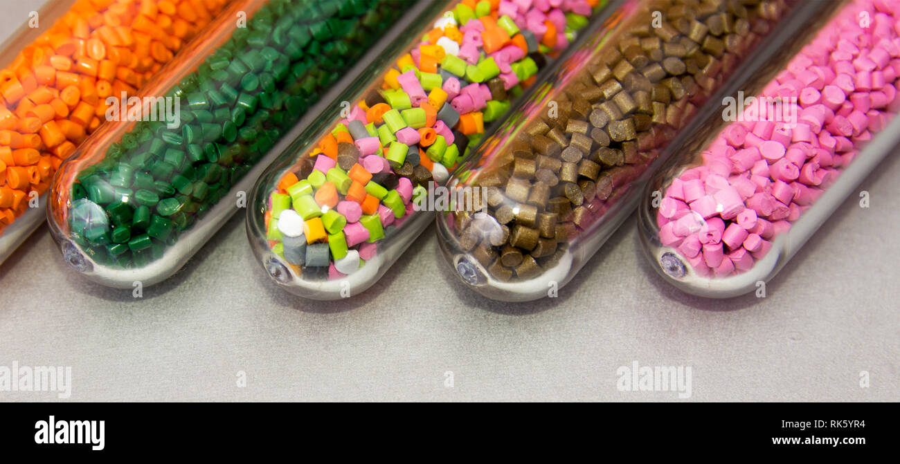 Plastic pellets .Polymeric dye in test tubes on gray background Stock ...