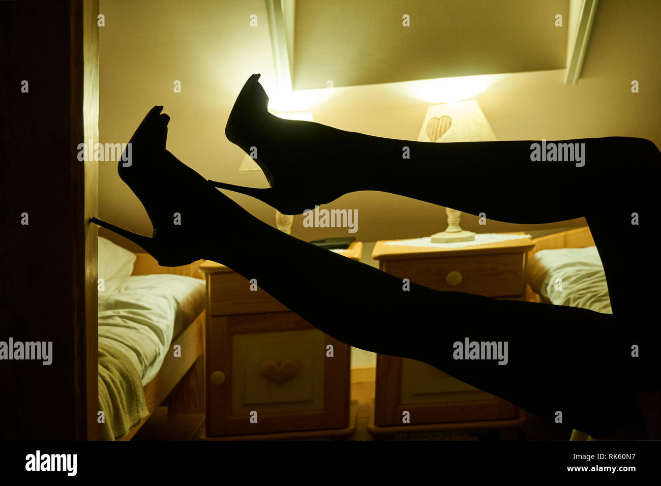 Feminine legs in elegant high heels in a hotel room Stock Photo - Alamy