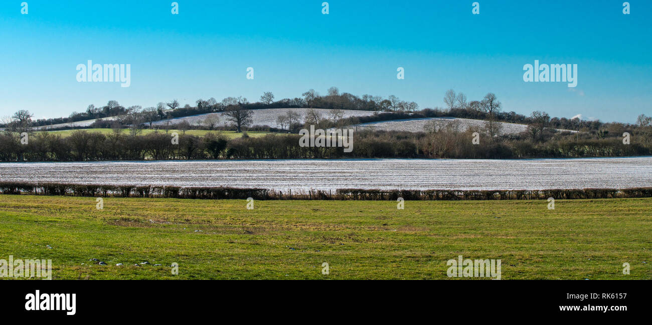 English Countryside in winter. Panorama of a gentle rounded hill with ...