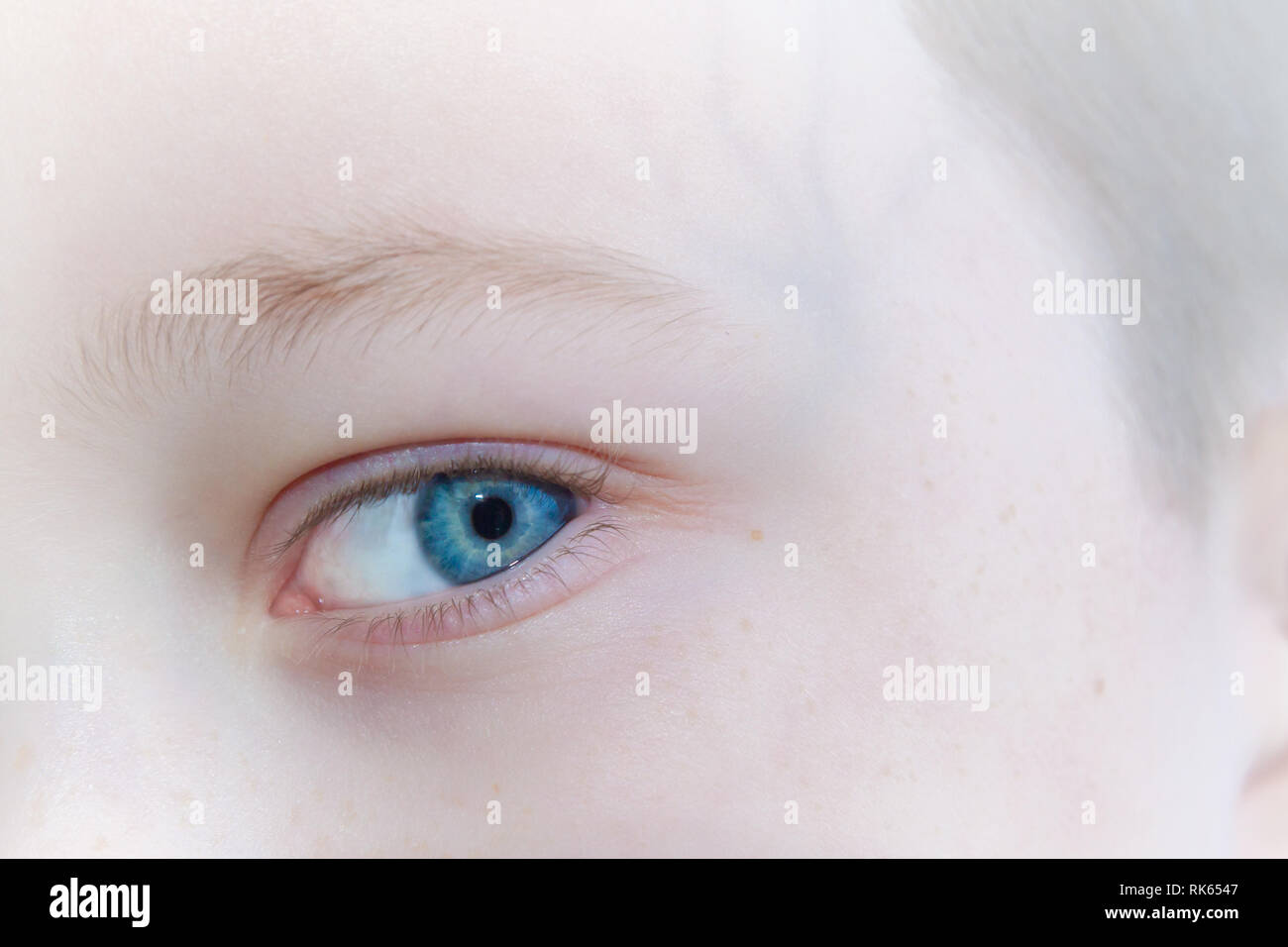 Baby blue beautiful, brooding eyes of a boy Stock Photo - Alamy