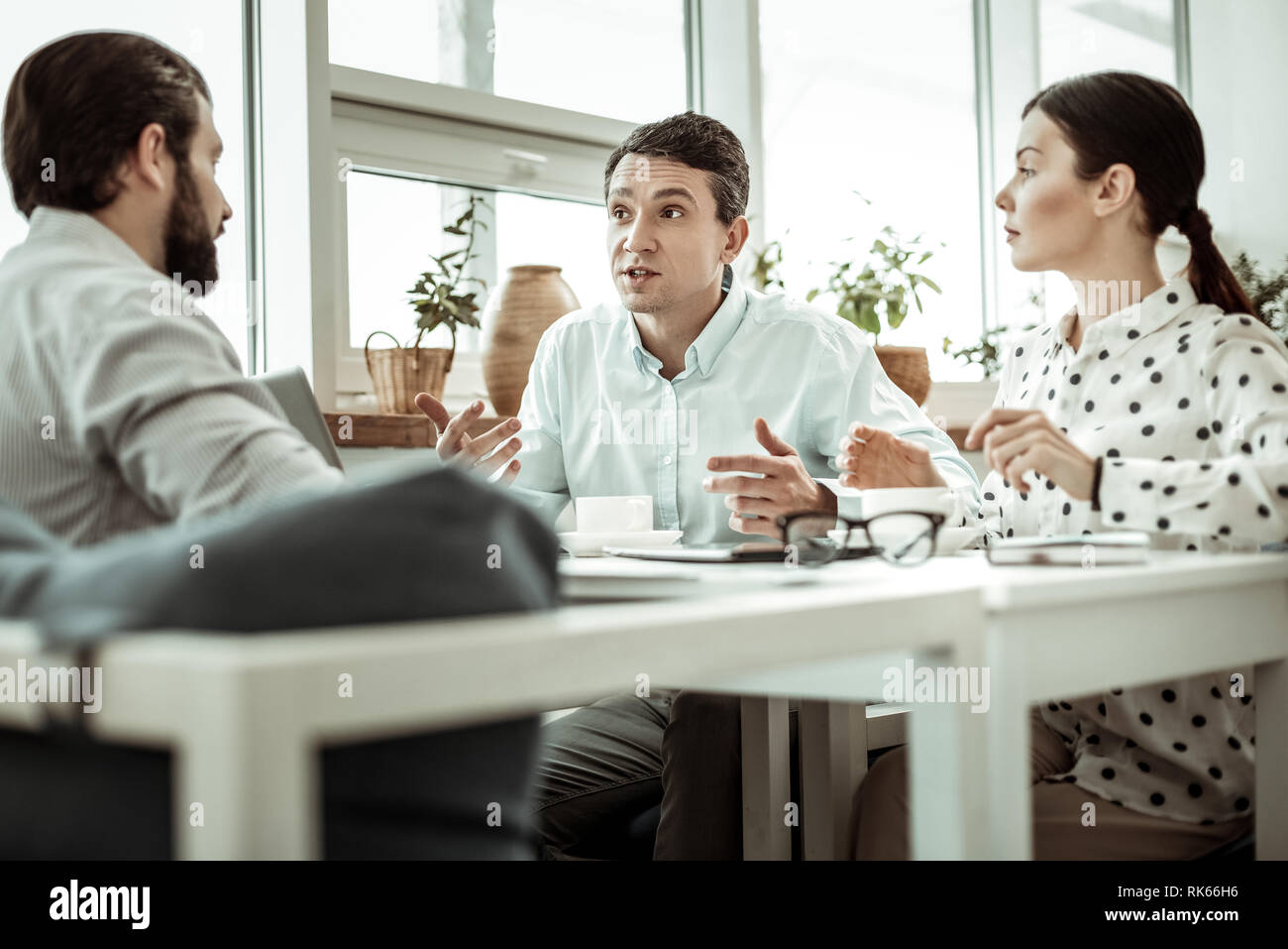 Emotional male person telling his business idea Stock Photo - Alamy