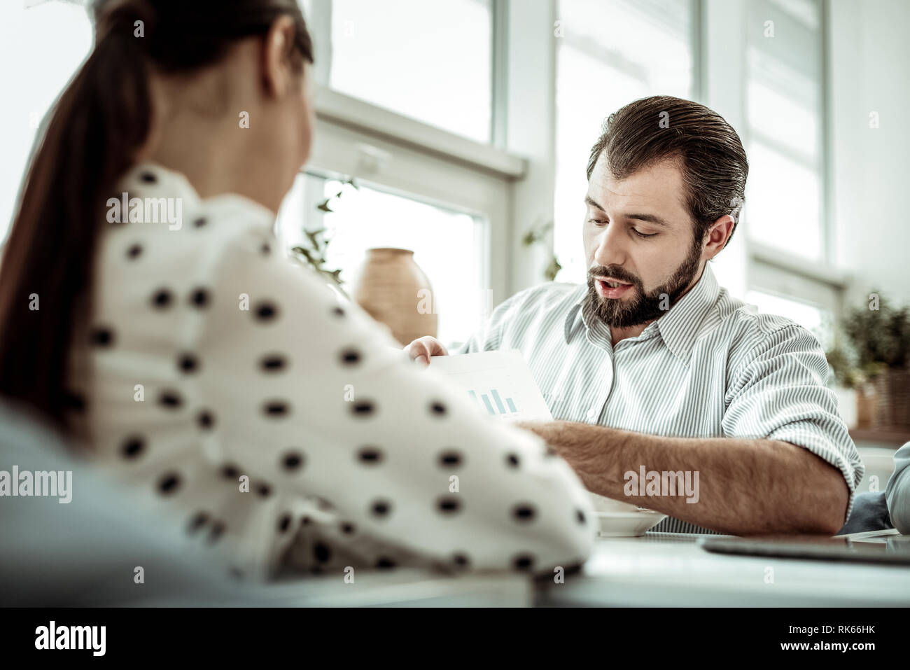 Concentrated brunette woman listening to her partner Stock Photo - Alamy