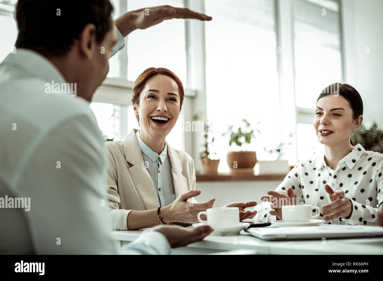 Cheerful female person laughing at funny situation Stock Photo - Alamy