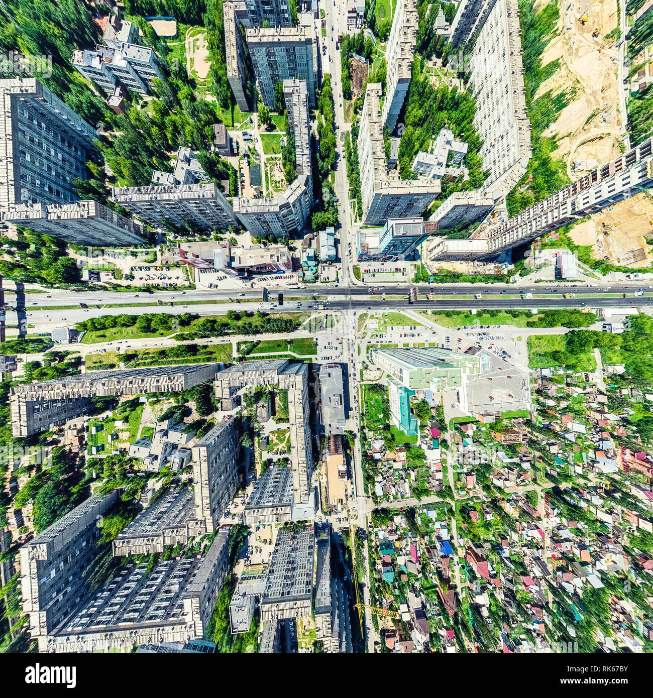 Aerial city view with crossroads and roads, houses, buildings, parks ...