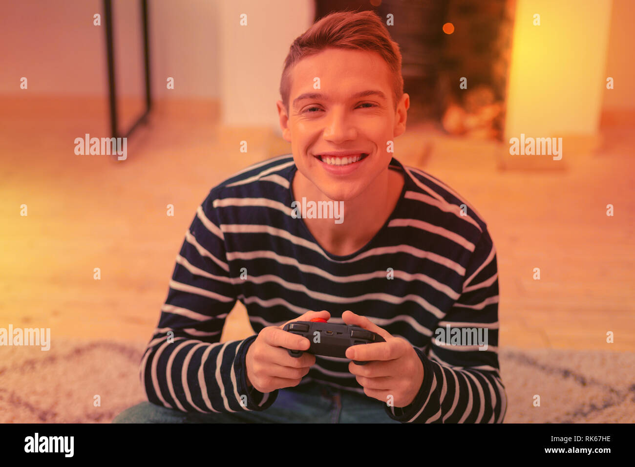 Positive jolly guy winning in console game Stock Photo - Alamy