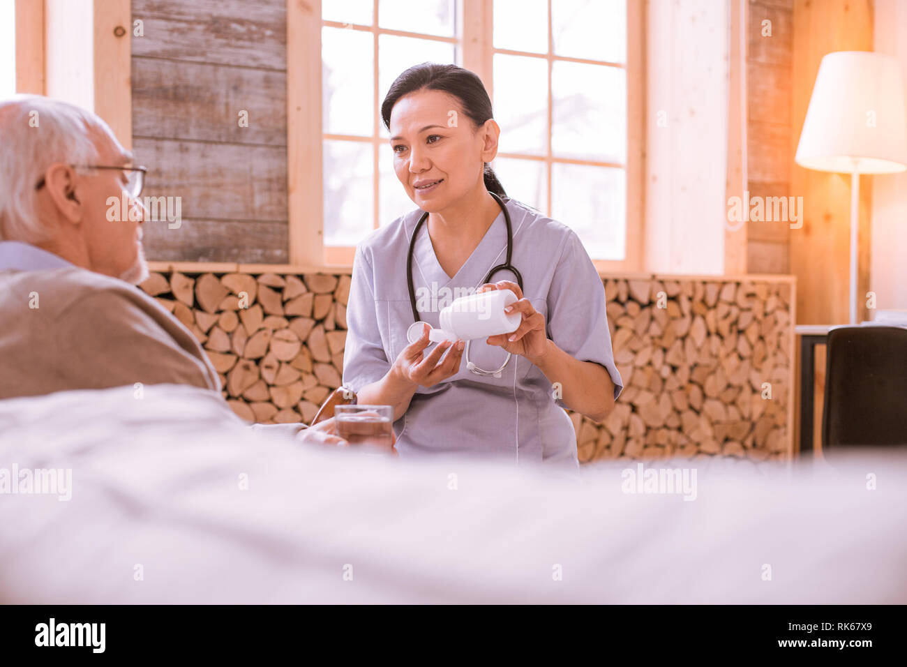 Pleased Asian medical worker giving professional support Stock Photo ...