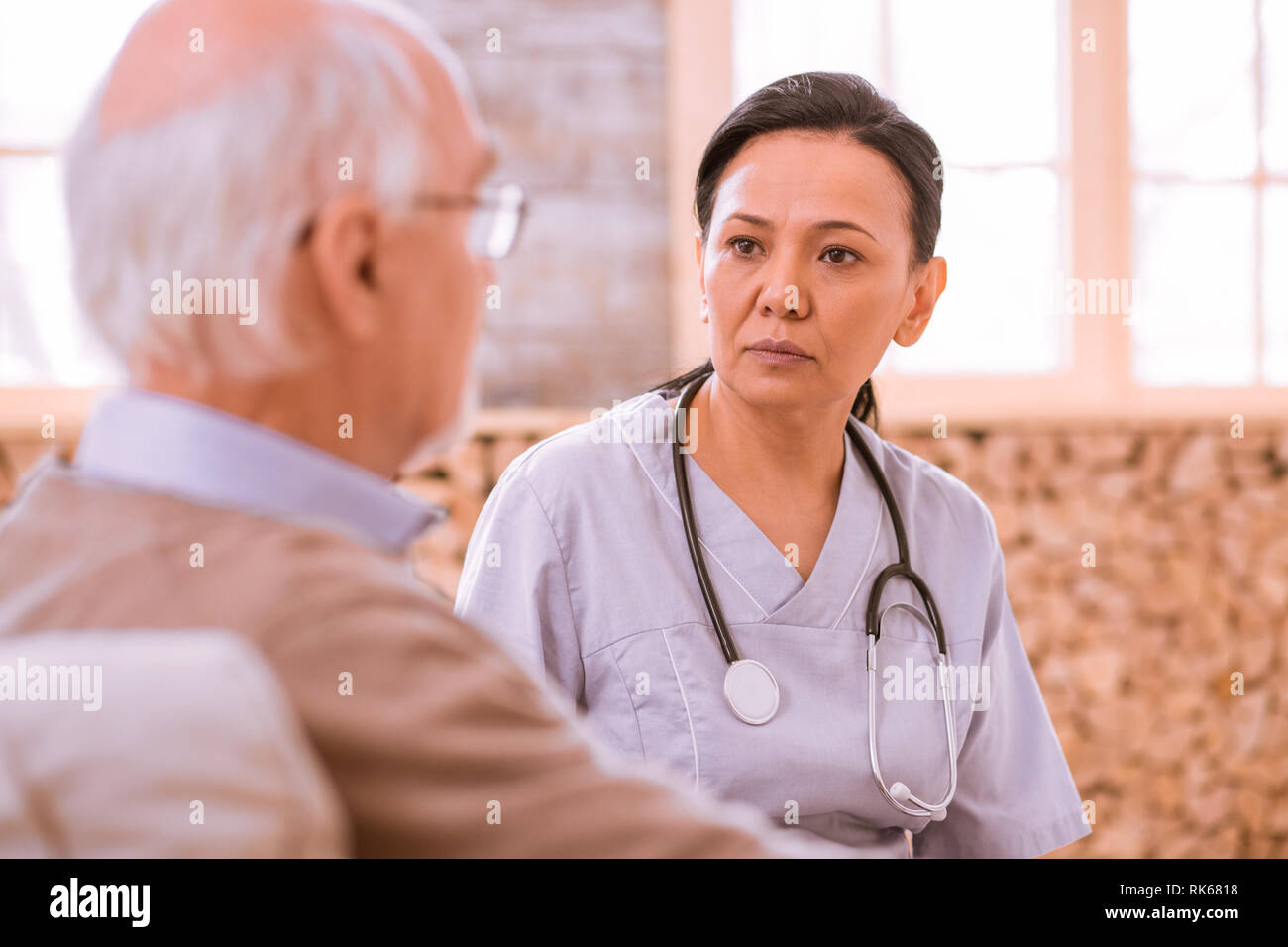Attentive young woman listening to her patient Stock Photo - Alamy
