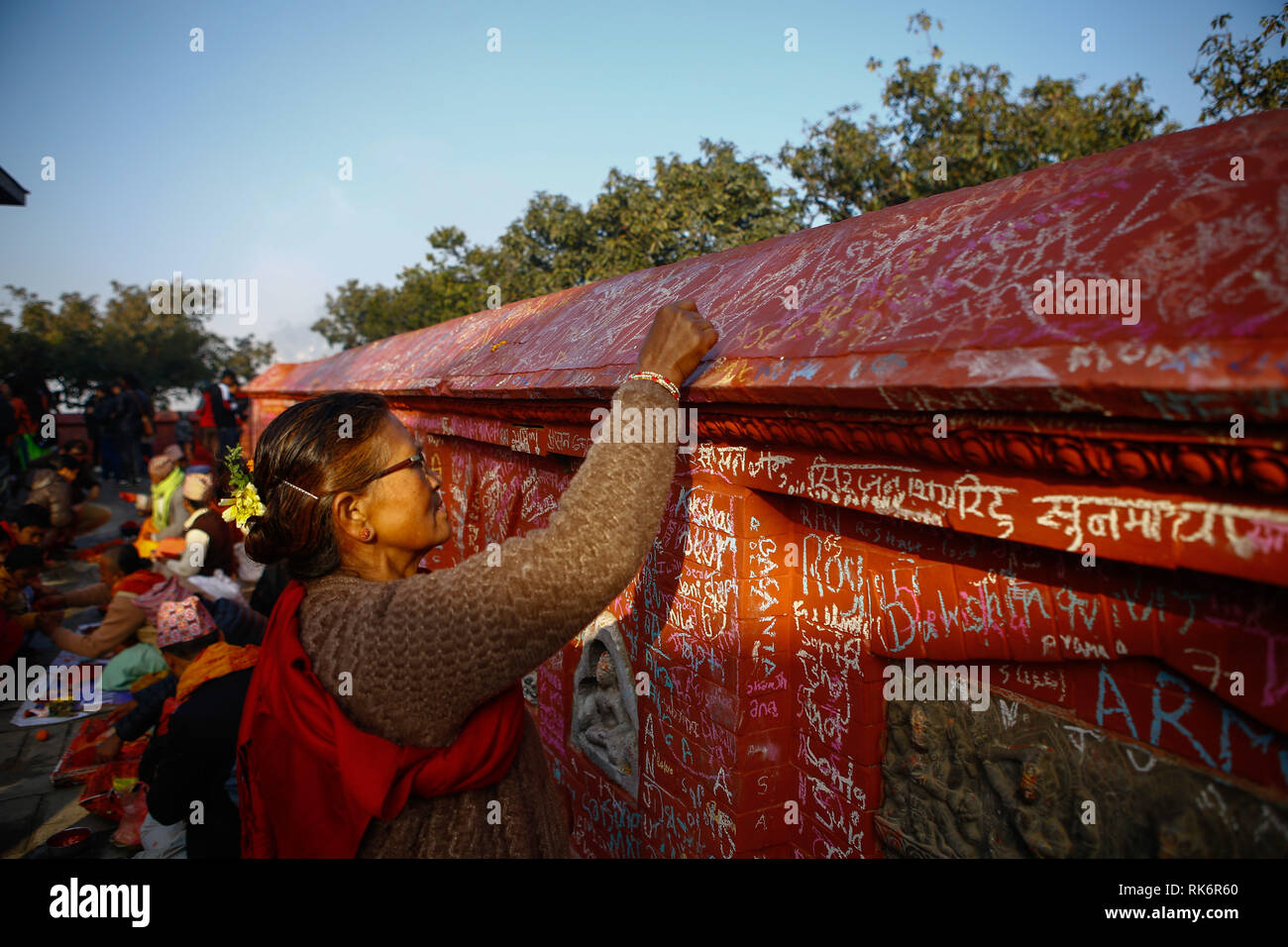 Kathmandu, Nepal. 10th Feb, 2019. A woman seen writing with chalk on ...