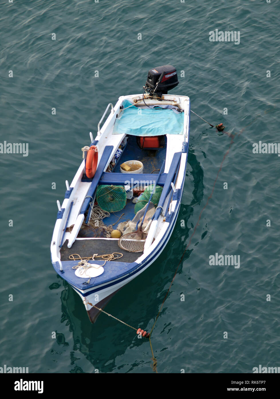 Boat shot from above on textured green sea water in the port of Githeio ...
