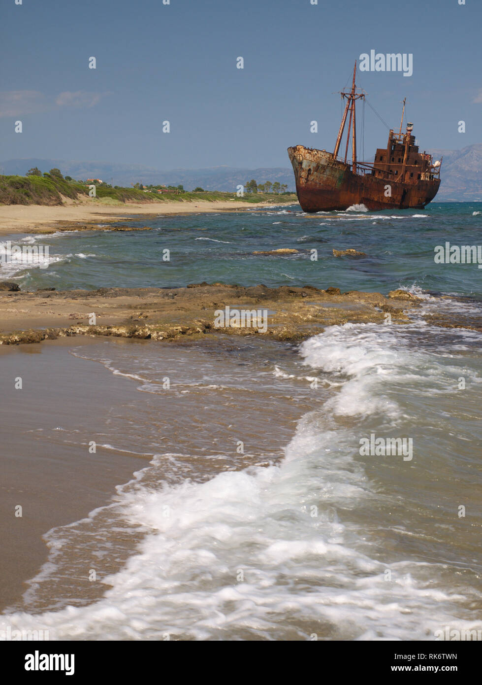 Rusty big ship shipwreck on Selinitsa beach under a deep blue sky at ...