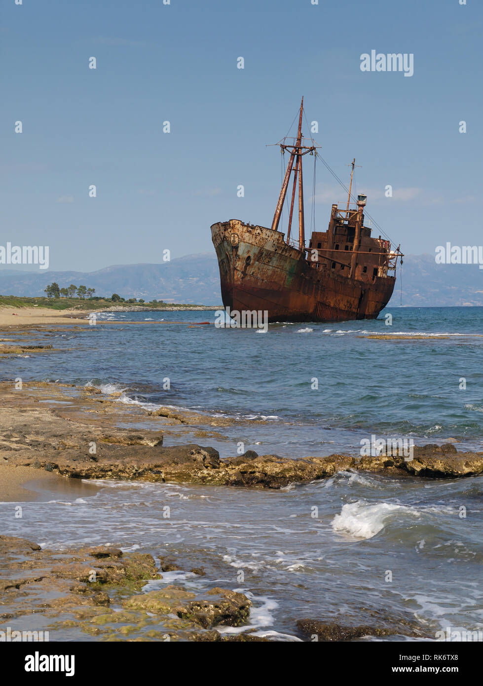 Rusty big ship shipwreck on Selinitsa beach under a deep blue sky at ...