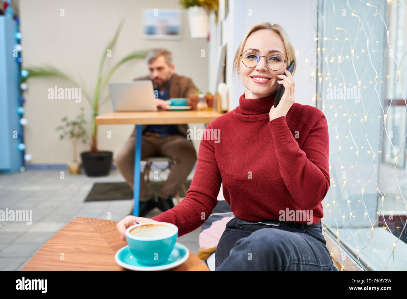 Cheerful blonde woman talking hi-res stock photography and images - Alamy