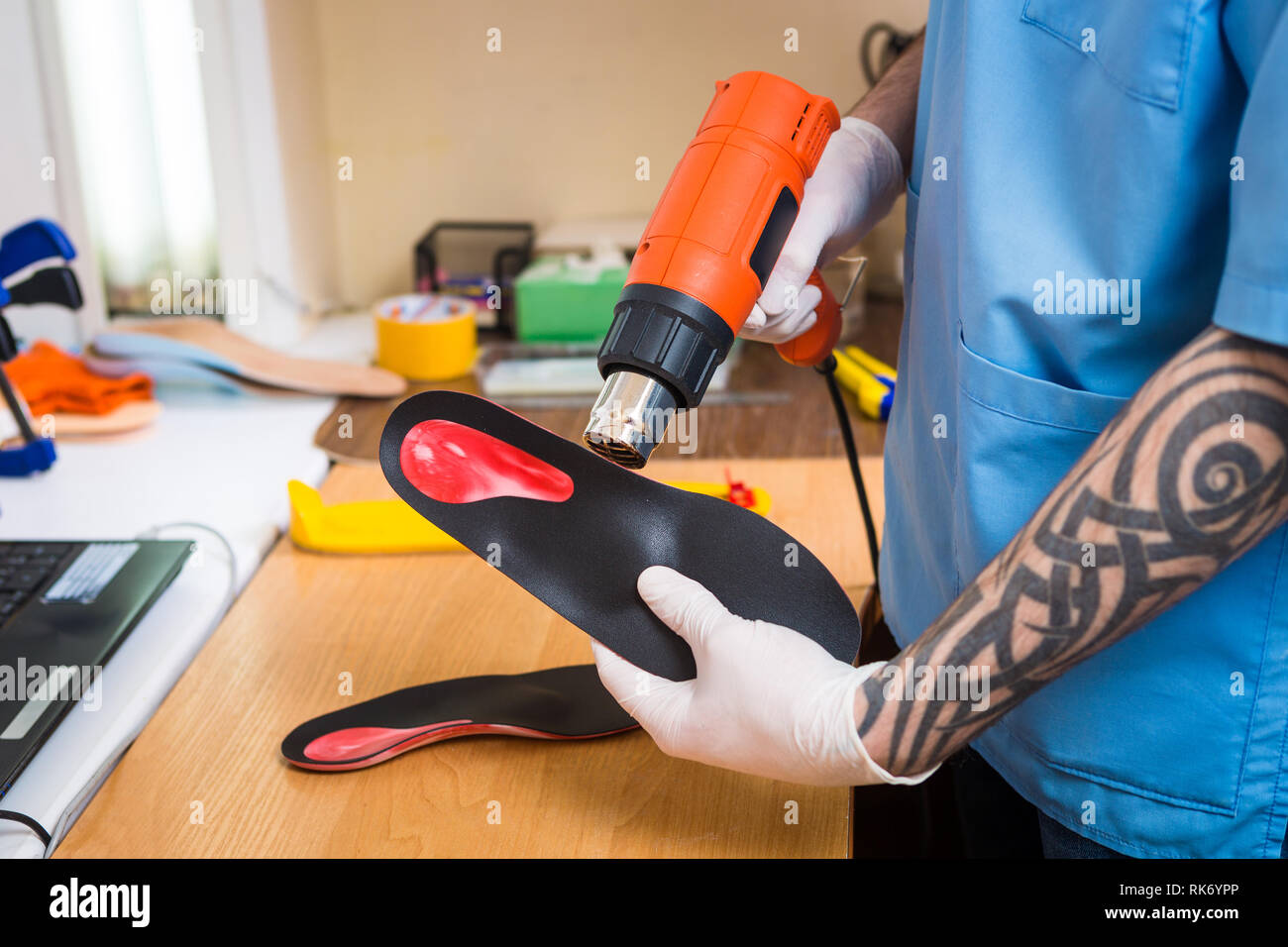 closeup Hands of young man with tattoo in workshop dressed in blue ...