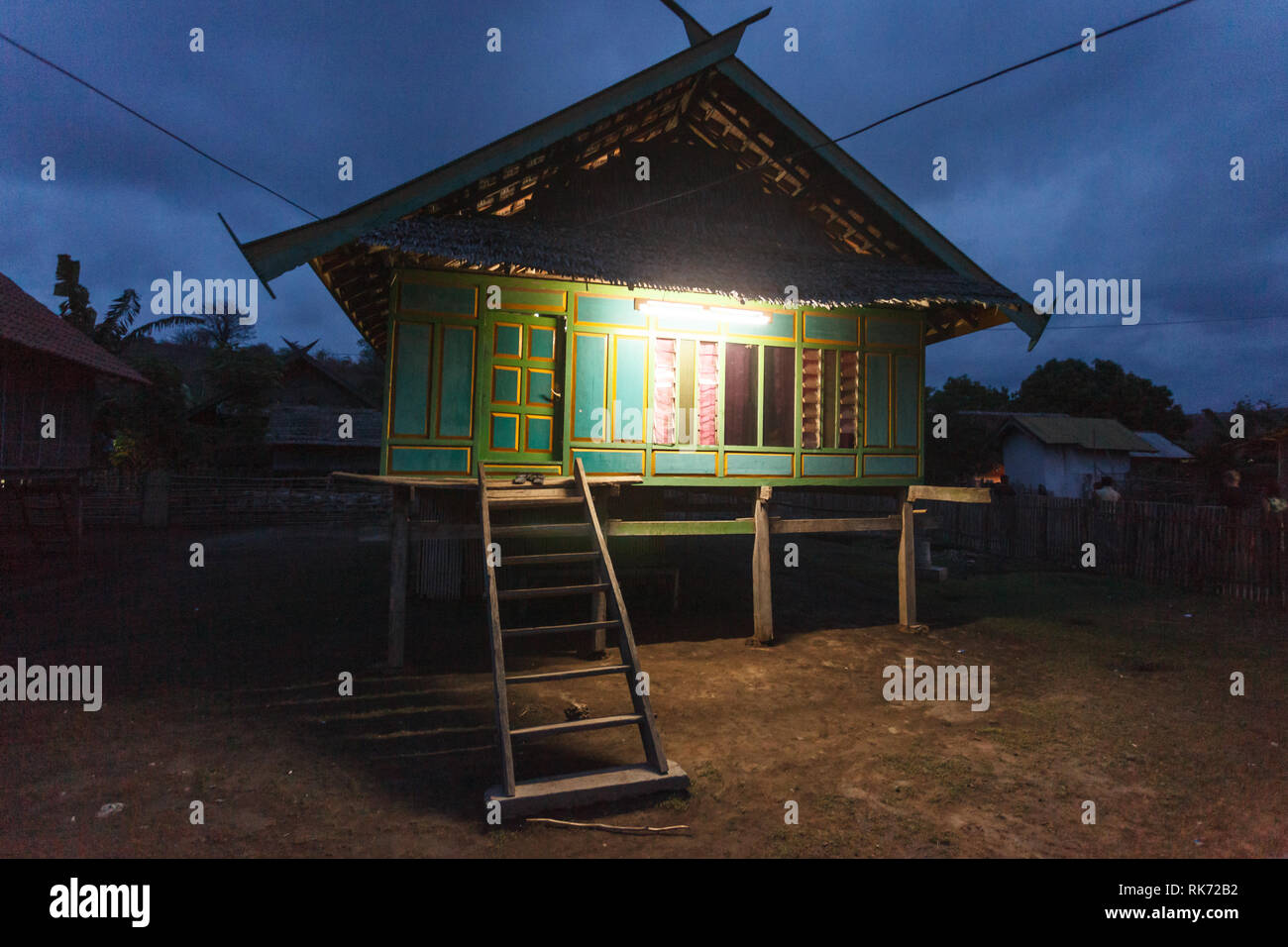 Native house painted bright green in Nusa Tenggara, Indonesia with ...