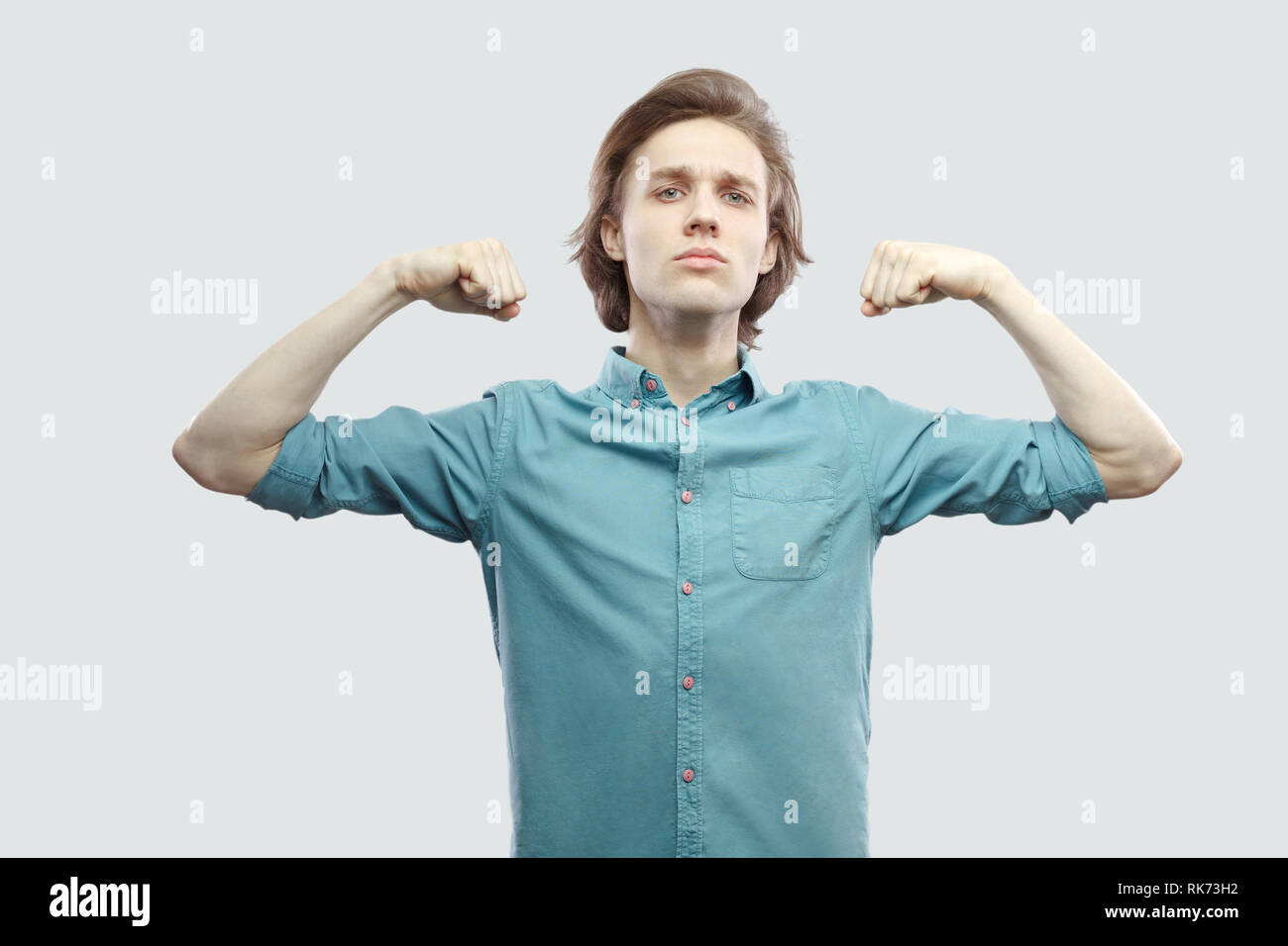 I am strong. Portrait of proud handsome long haired blonde young man in ...